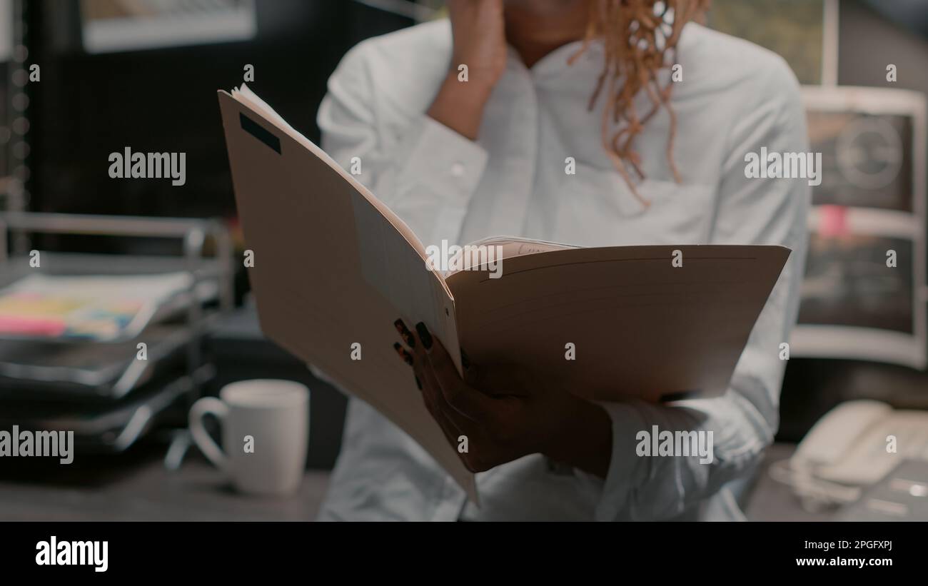 Professional agent studying case evidence on files, holding reports ...