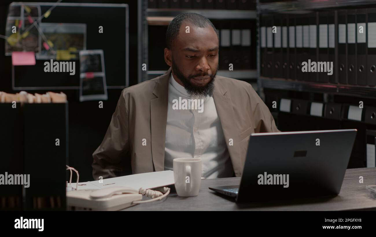 Investigator studying folder with police archive records in incident ...