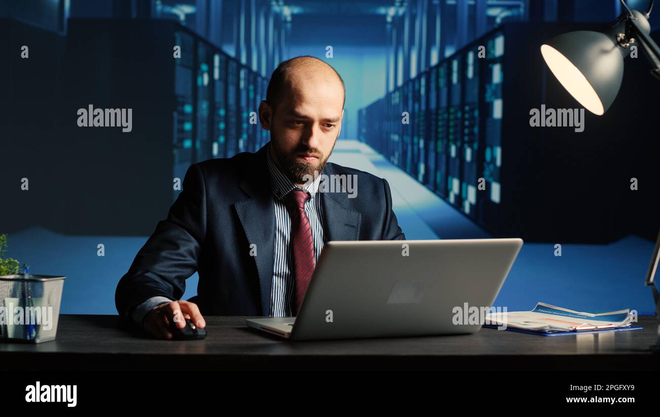 Frustrated database admin making mistake in data center, working under pressure with mainframe ...