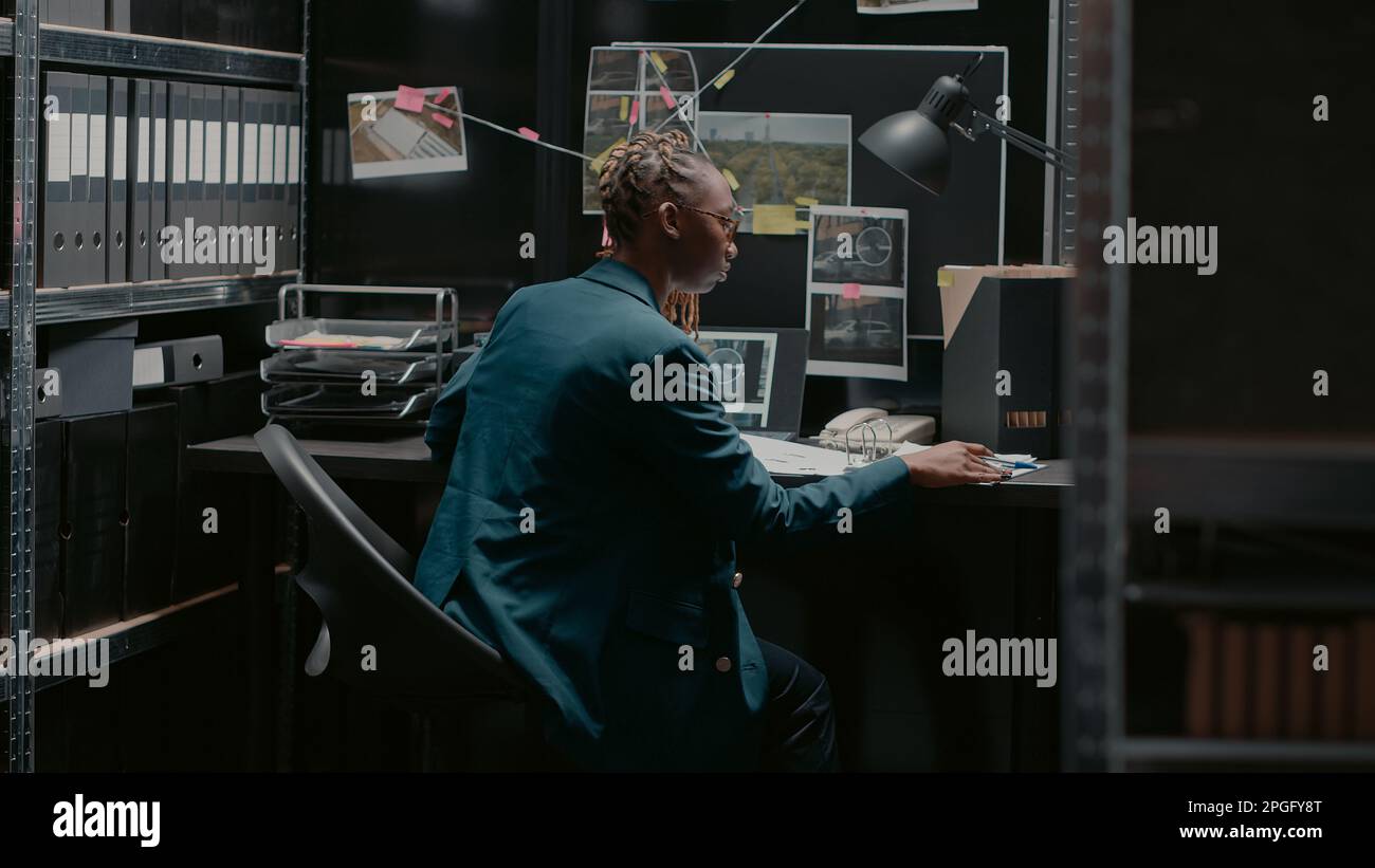 Police investigator examining clues from crime scene, looking at ...