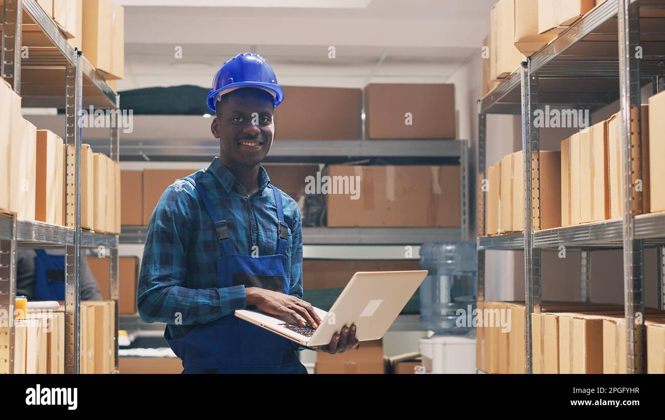 Warehouse employee counting goods boxes on racks, checking stock list ...