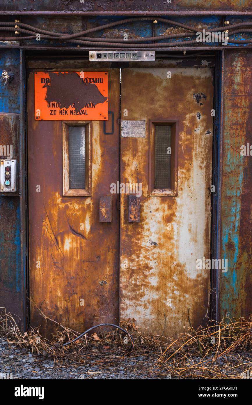 Steel, rusty door to a relic, no longer working industrial elevator in ...