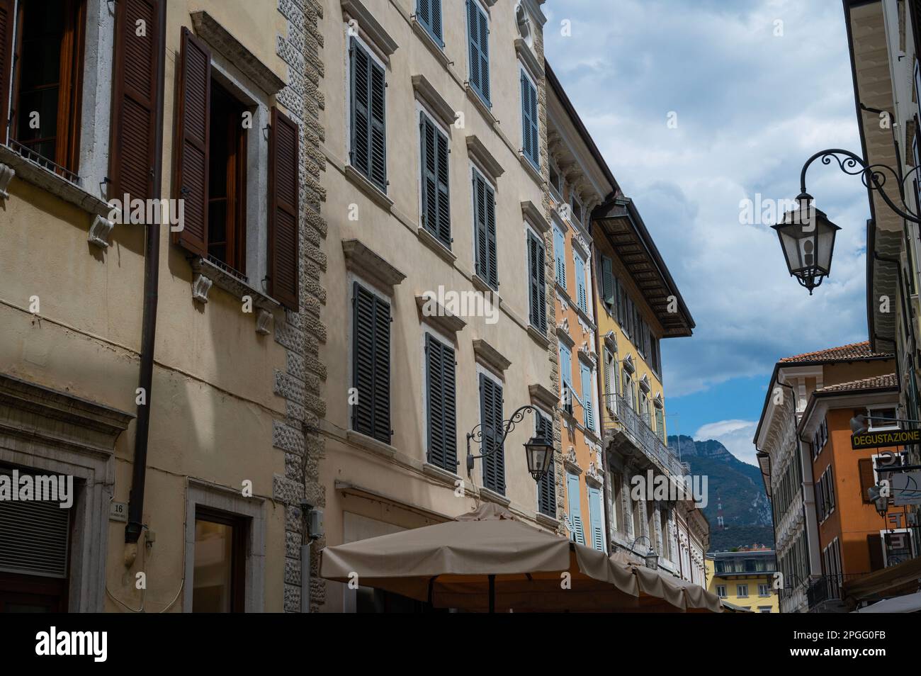 Colourful stucco building and narrow streets of Riva Sul Garda, the old ...