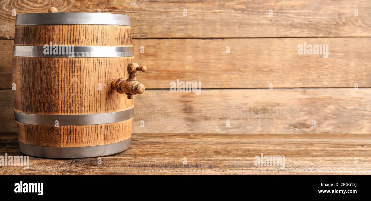 Barrel on wooden background with space for text Stock Photo - Alamy