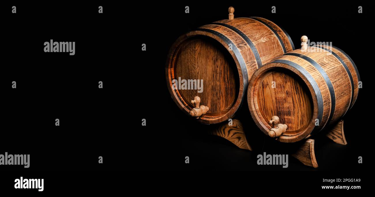 Wooden barrels on dark background with space for text Stock Photo - Alamy