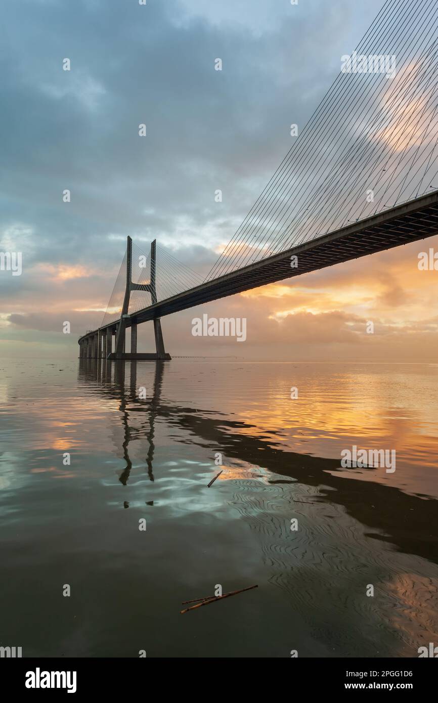 Background with colourful sunrise on the Lisbon bridge. The Vasco da ...