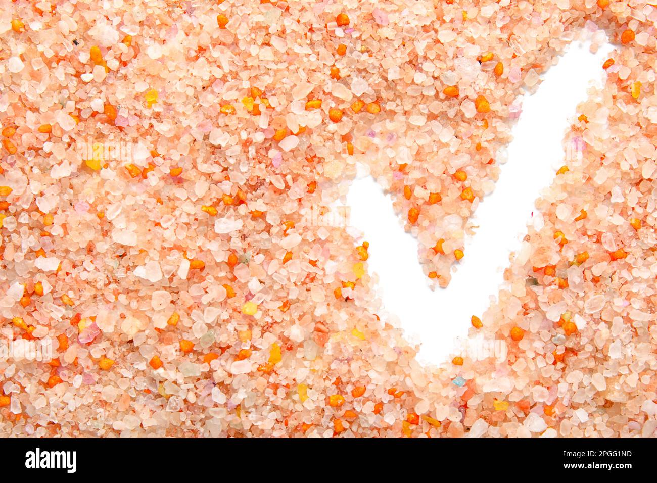 Check mark made of sea salt on white background Stock Photo - Alamy