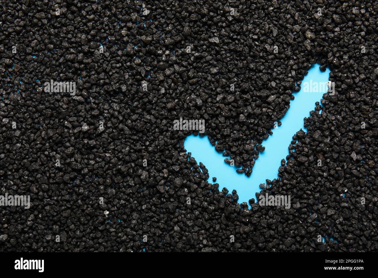 Check mark made of charcoal on blue background Stock Photo - Alamy