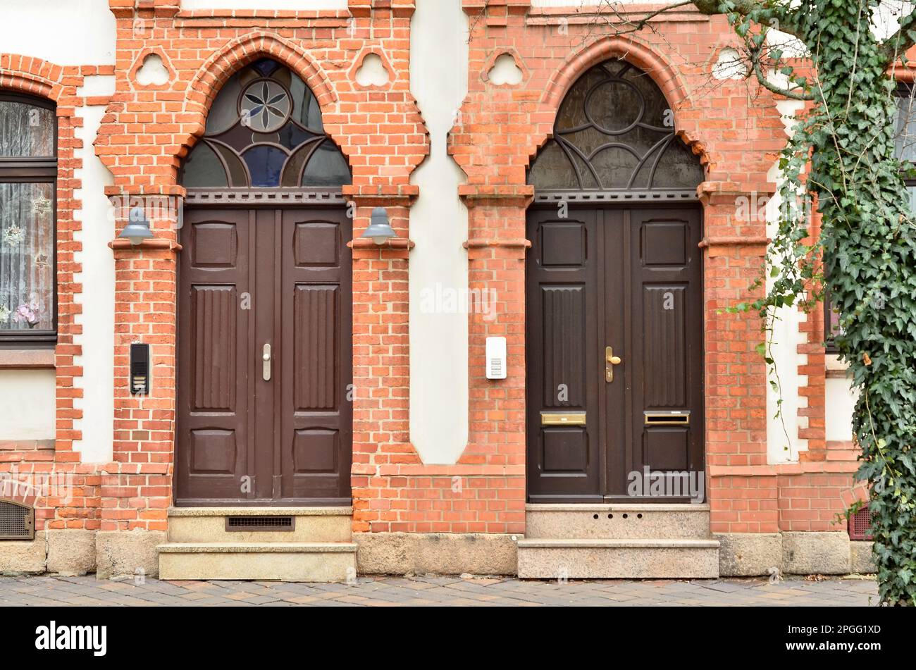 View of brick building with wooden doors Stock Photo - Alamy