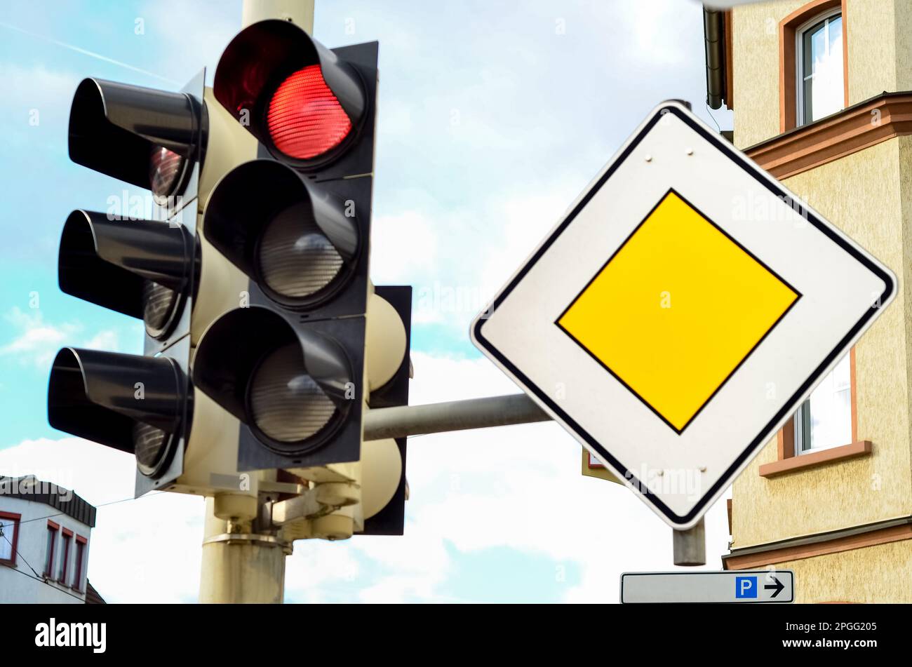 Main road sign and traffic lights in city, closeup Stock Photo - Alamy