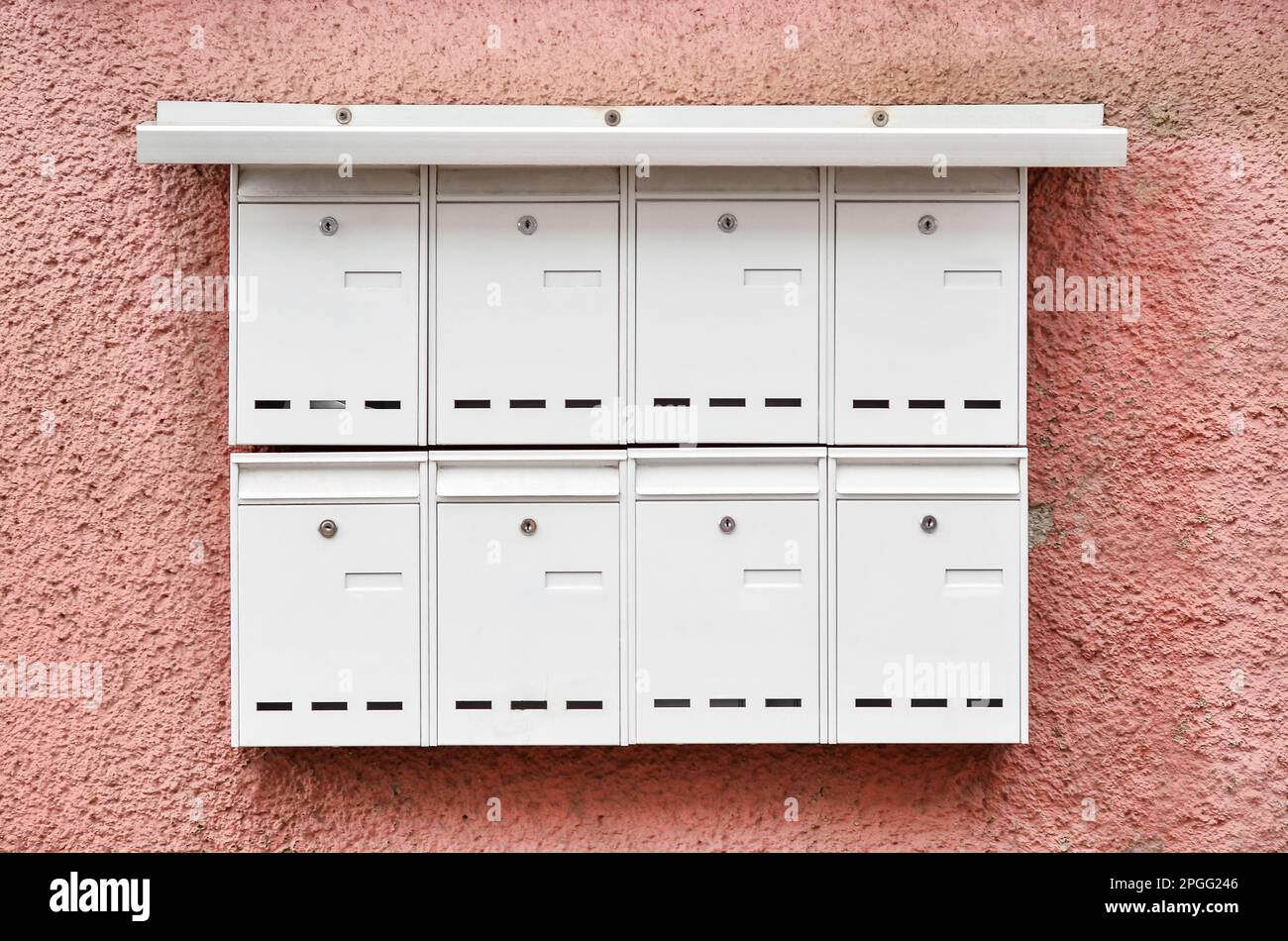 View of white mailboxes on building wall Stock Photo - Alamy