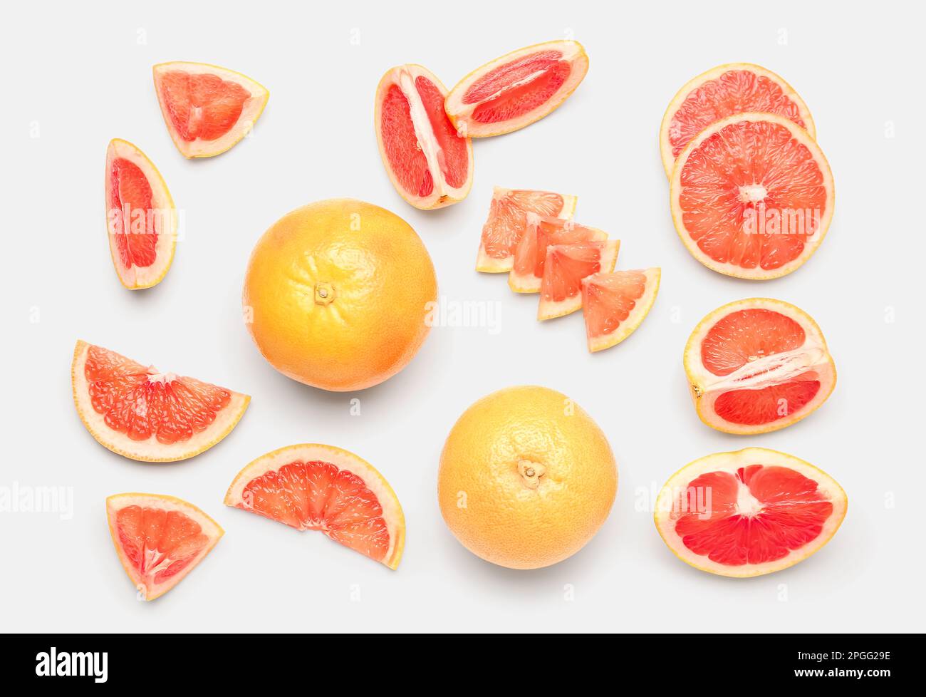 Composition with cut and whole ripe grapefruits on white background ...