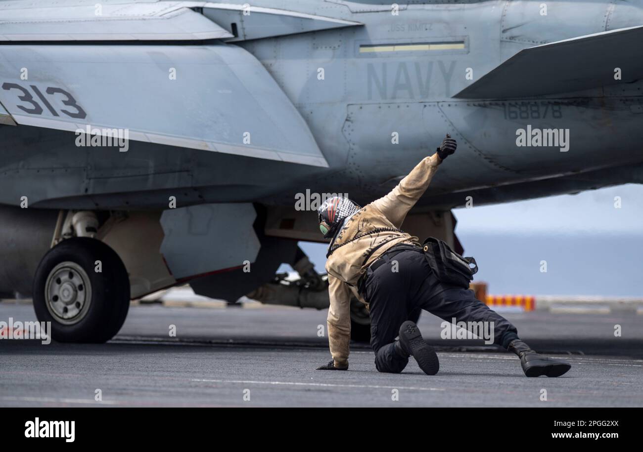 230322-N-DU622-1320 PHILIPPINE SEA (March 22, 2023) A U.S. Navy Sailor checks an F/A-18E Super ...