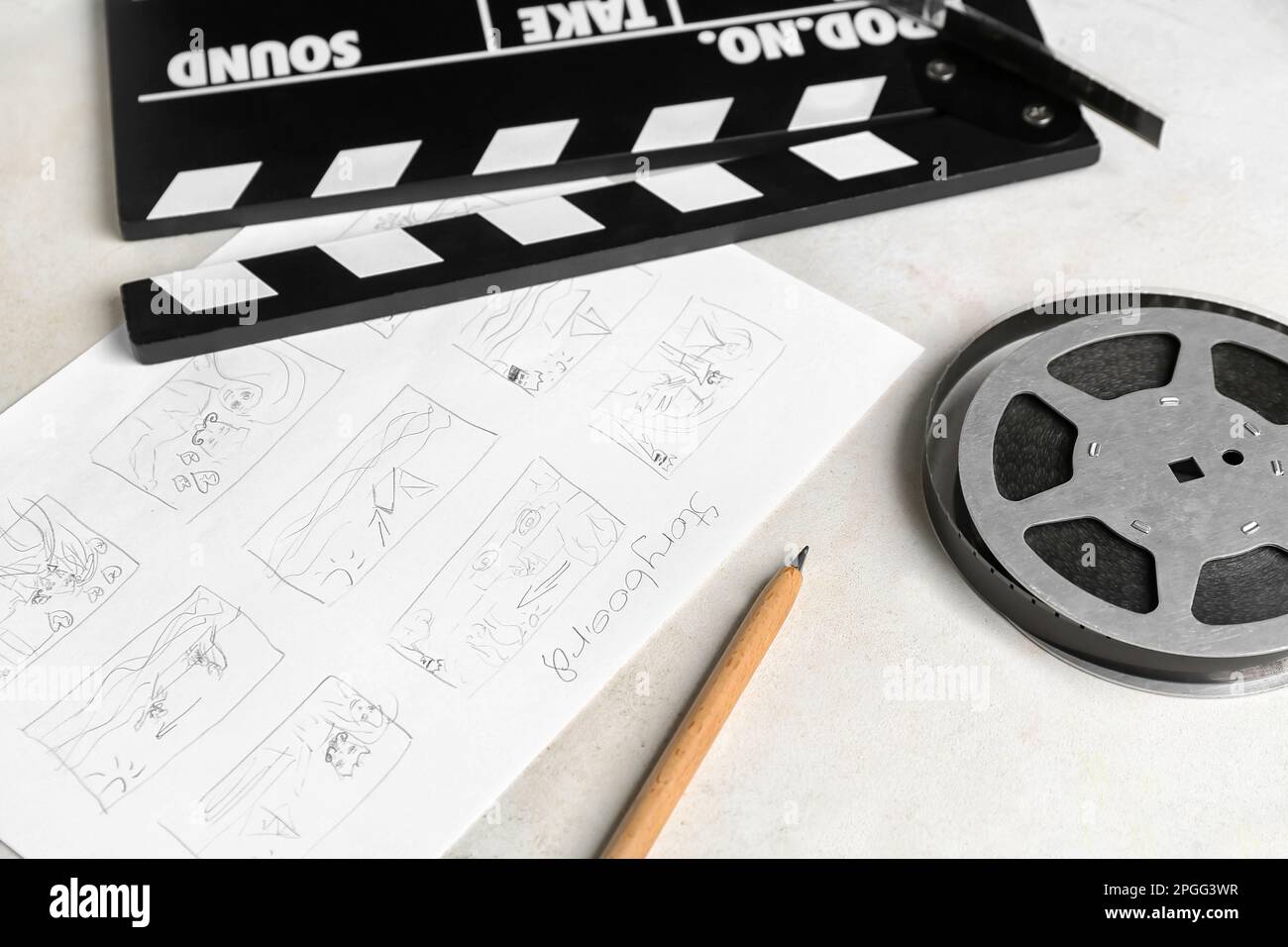 Movie clapper with storyboard and film reel on light background ...