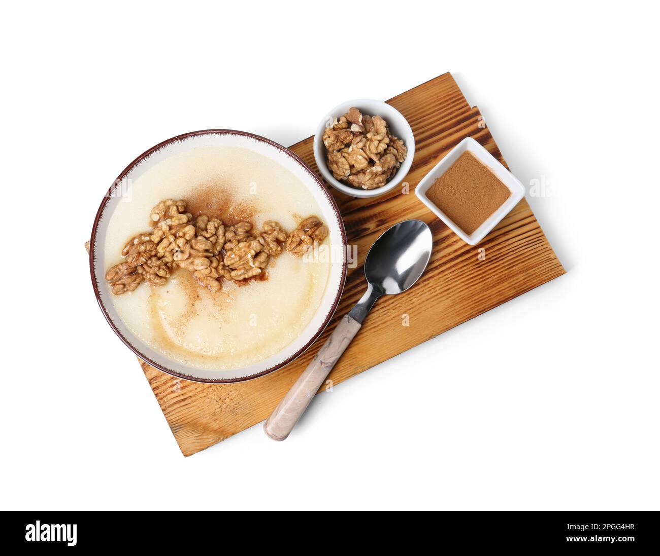Bowl of tasty semolina porridge with nuts and cinnamon on white ...