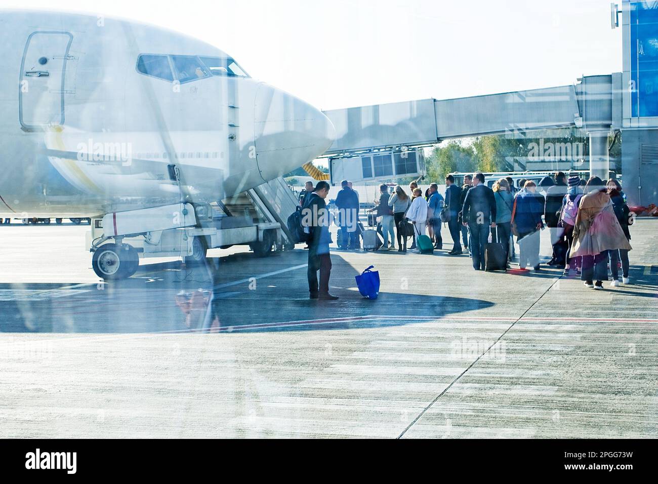 Passengers boarding the plane Stock Photo - Alamy