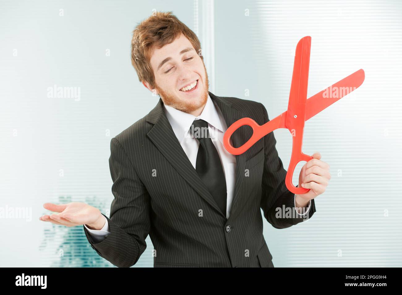 Employer with one scissors in one hand and the other open palm up in a ...