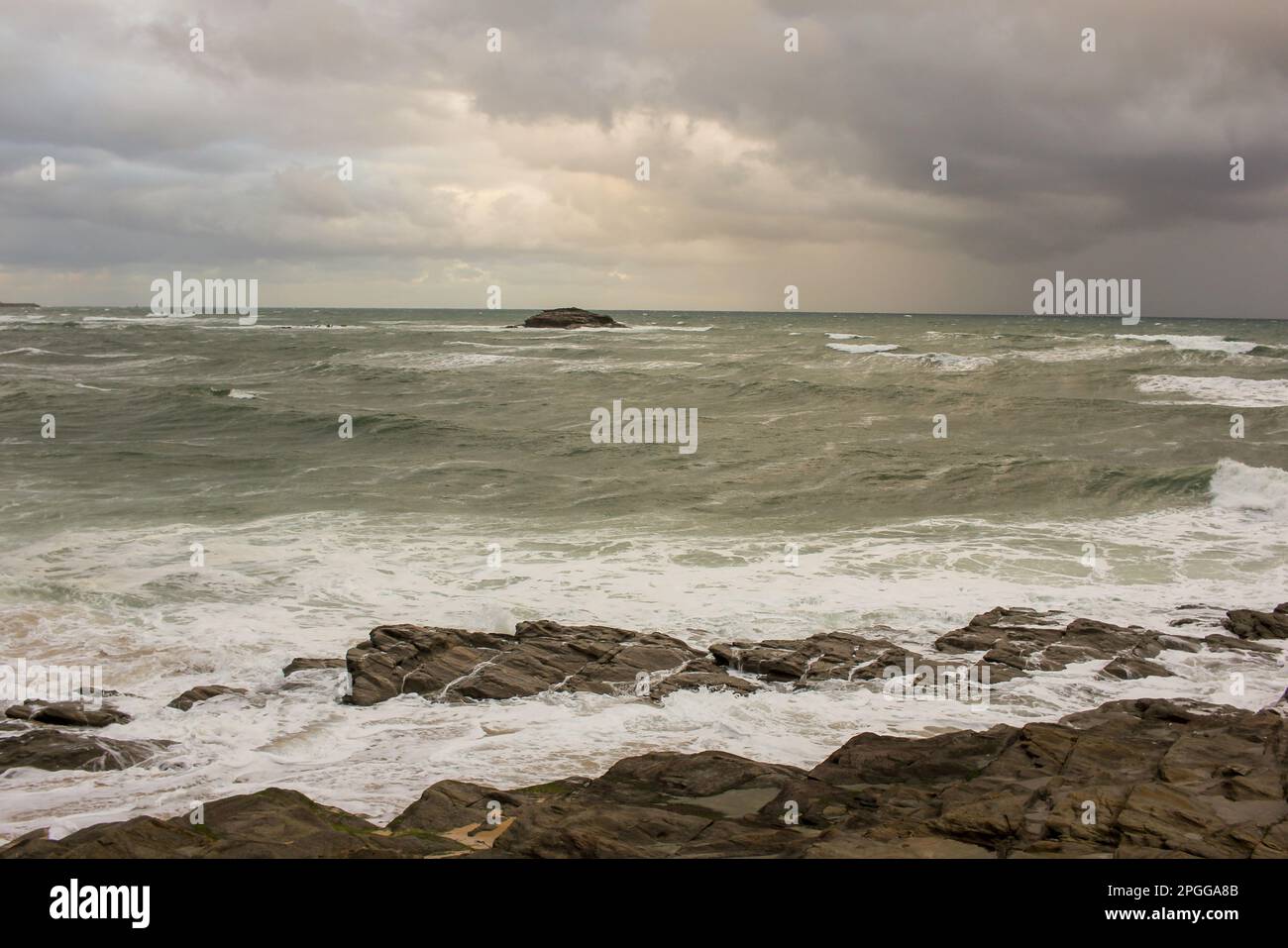 The Cantabrian sea is rough under a cloudy sky and in a windy day Stock ...