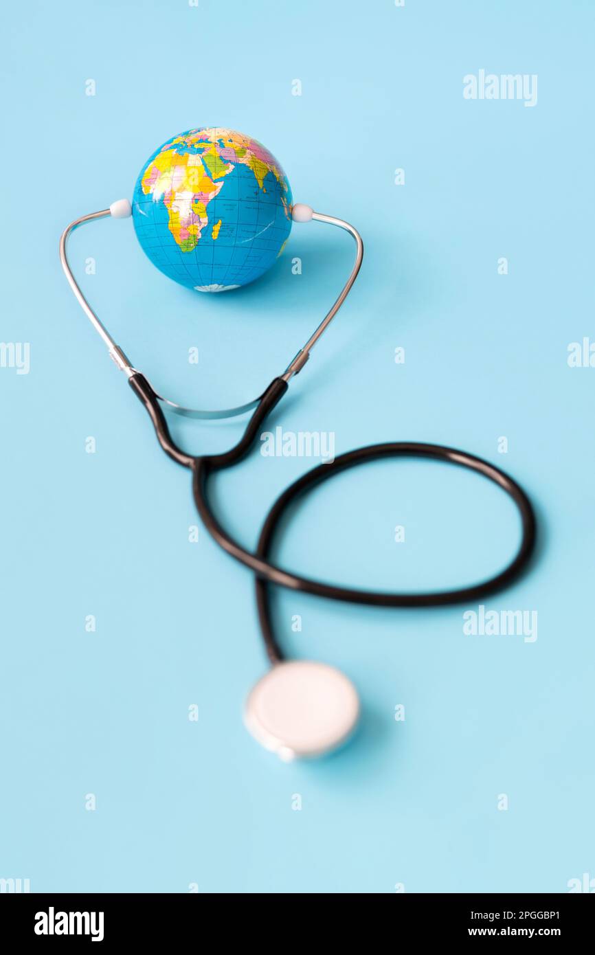World ball and stethoscope isolated on light blue background. Worldwide ...
