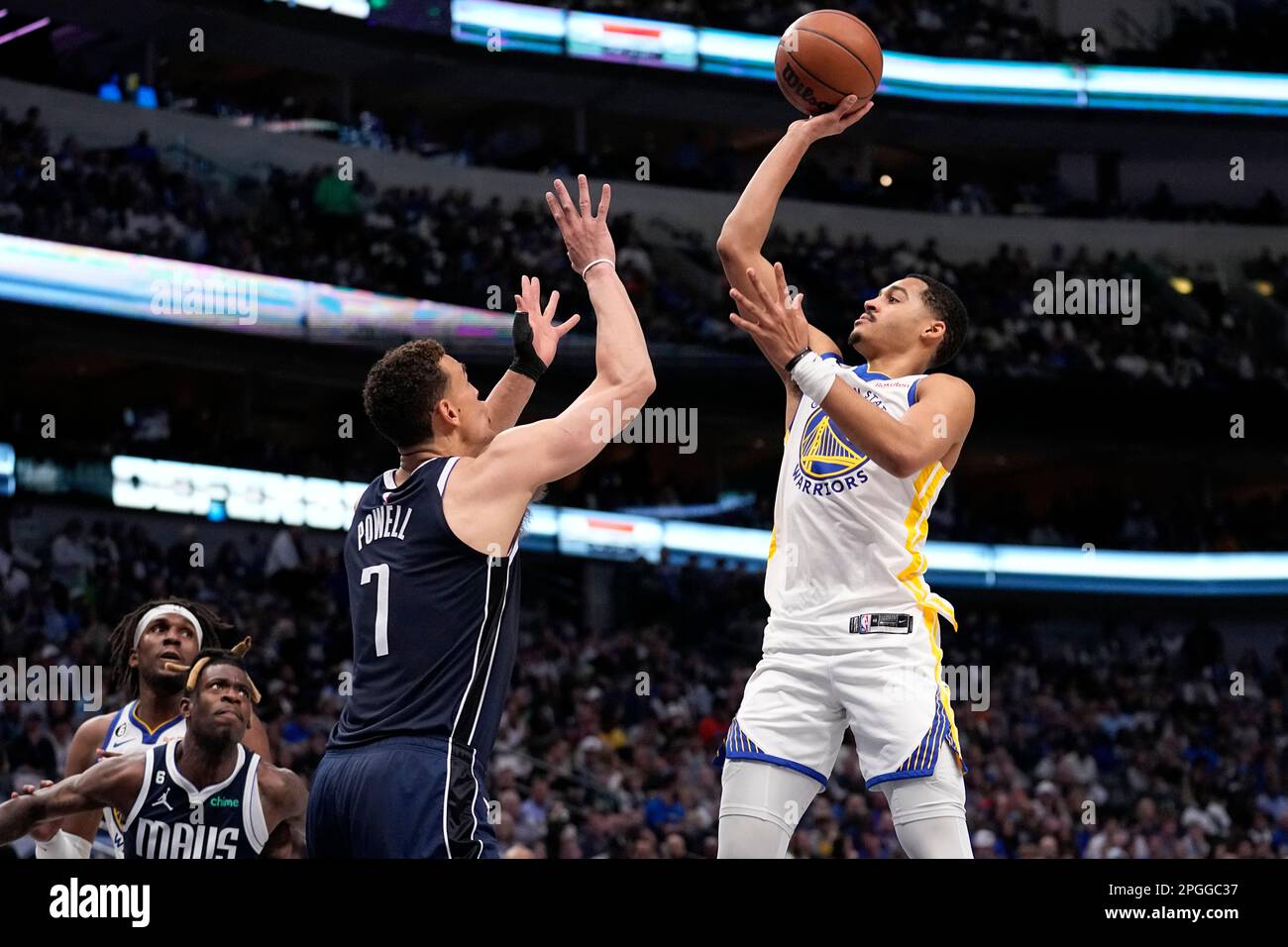 Golden State Warriors guard Jordan Poole, right, takes a shot as Dallas ...