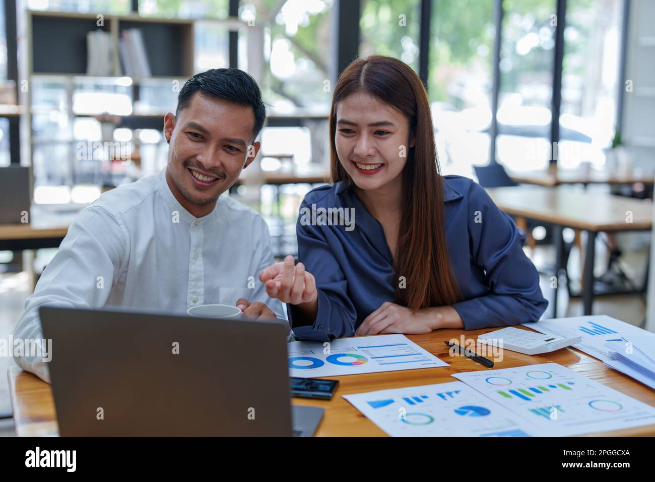 startup business, portrait of two entrepreneurs using computers and ...