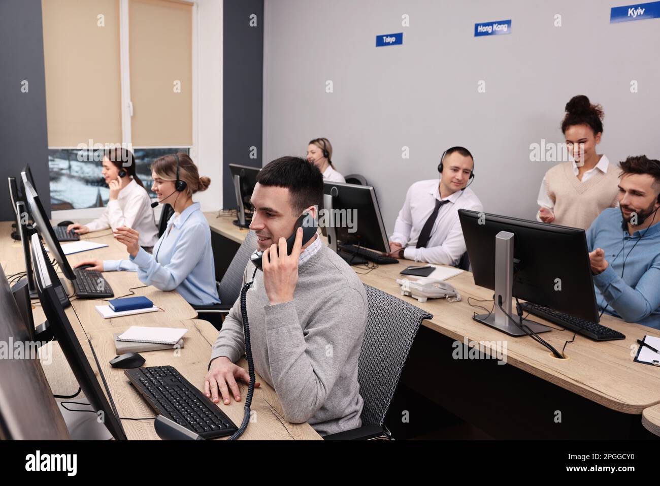 Call center operators working in modern office Stock Photo - Alamy