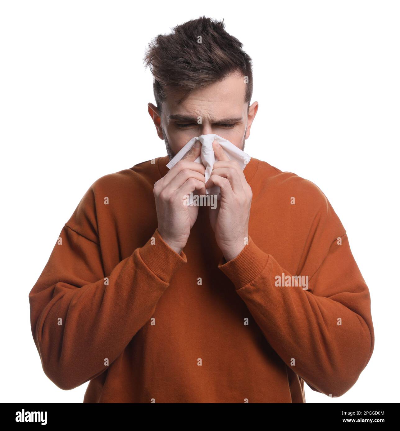 Sick man sneezing on white background. Cold symptoms Stock Photo - Alamy