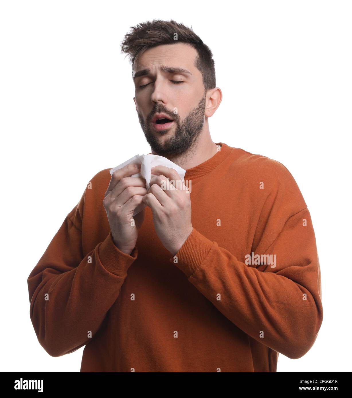 Sick man sneezing on white background. Cold symptoms Stock Photo - Alamy