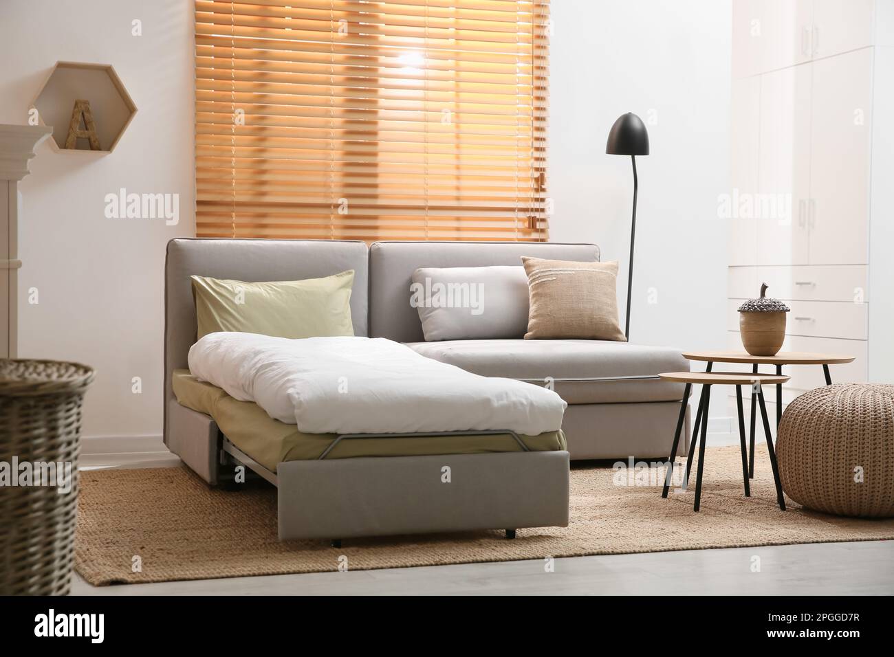 Room interior with sleeper sofa near window Stock Photo - Alamy