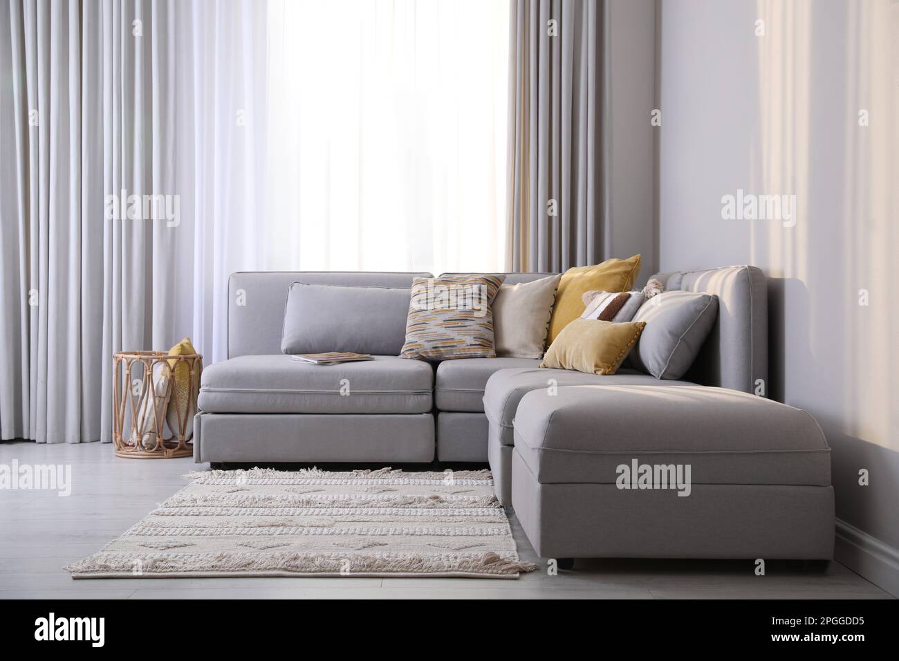 Living room interior with large grey sofa Stock Photo - Alamy