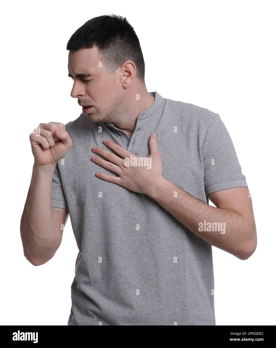 Young man coughing on white background. Cold symptoms Stock Photo - Alamy