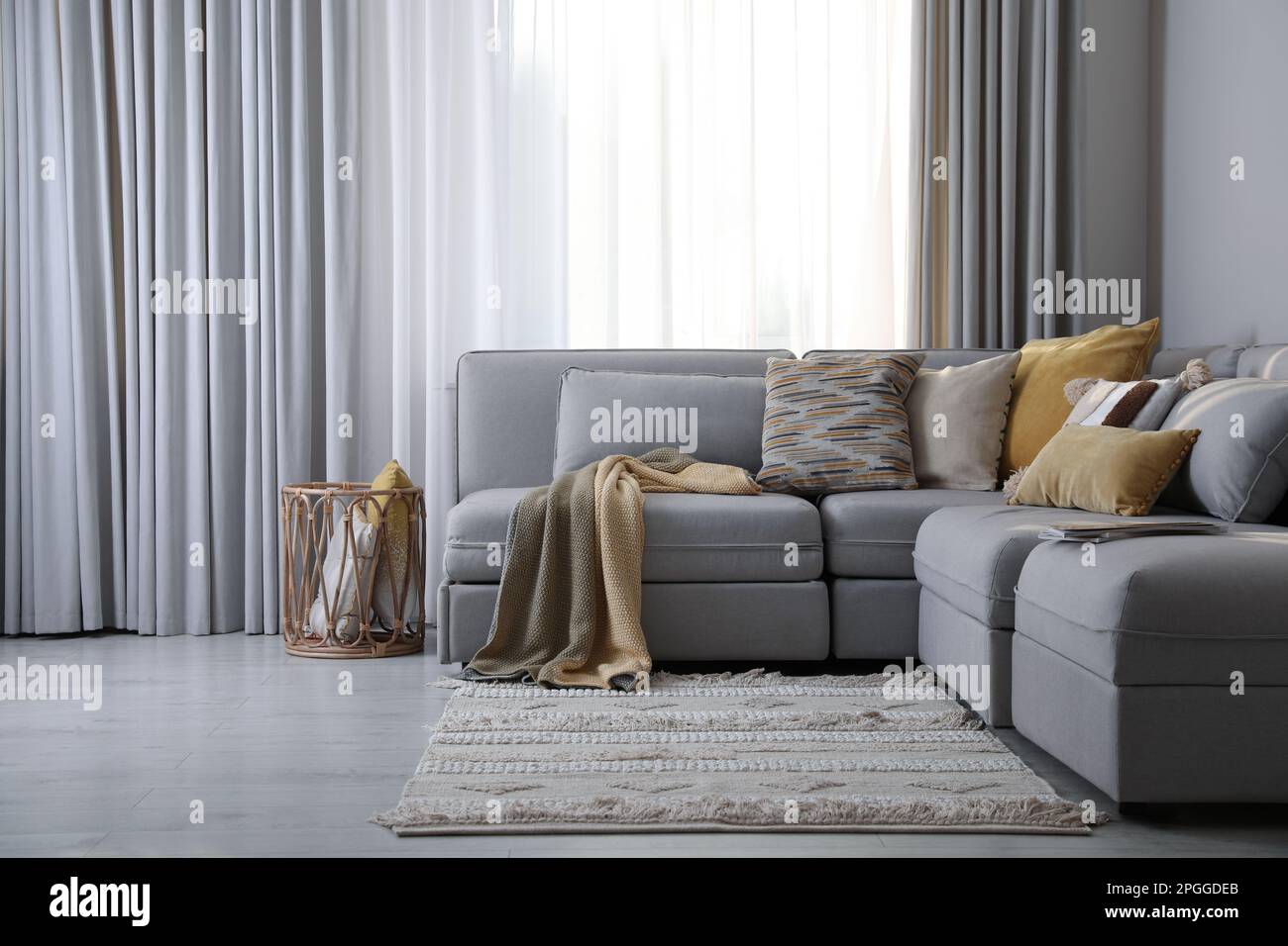 Living room interior with large grey sofa Stock Photo - Alamy