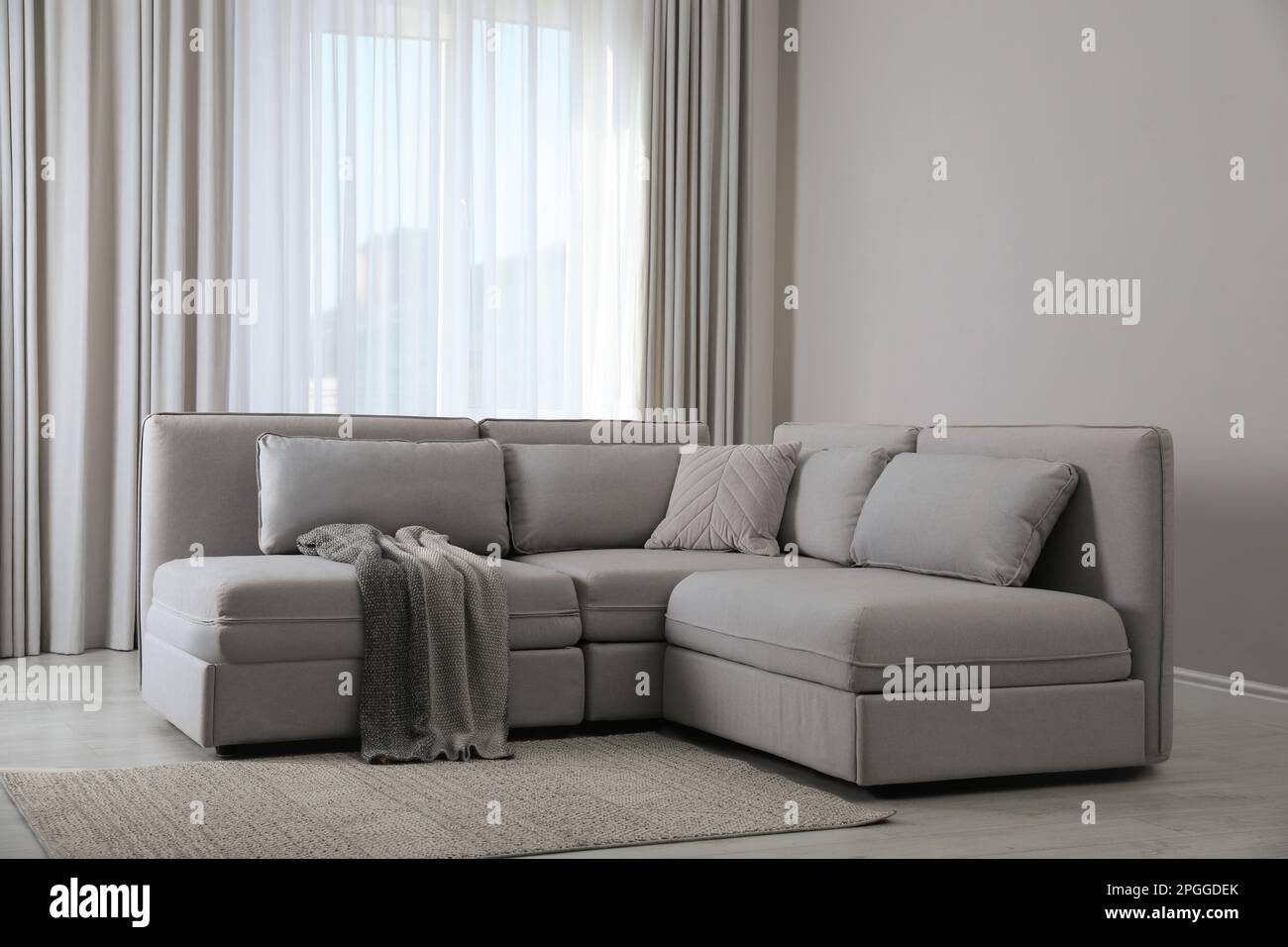 Large grey sofa in living room. Interior design Stock Photo - Alamy