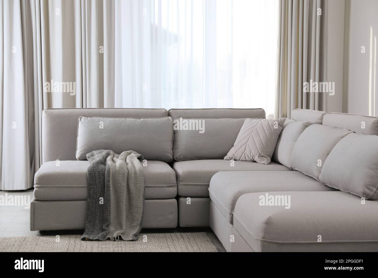 Large grey sofa in living room. Interior design Stock Photo - Alamy