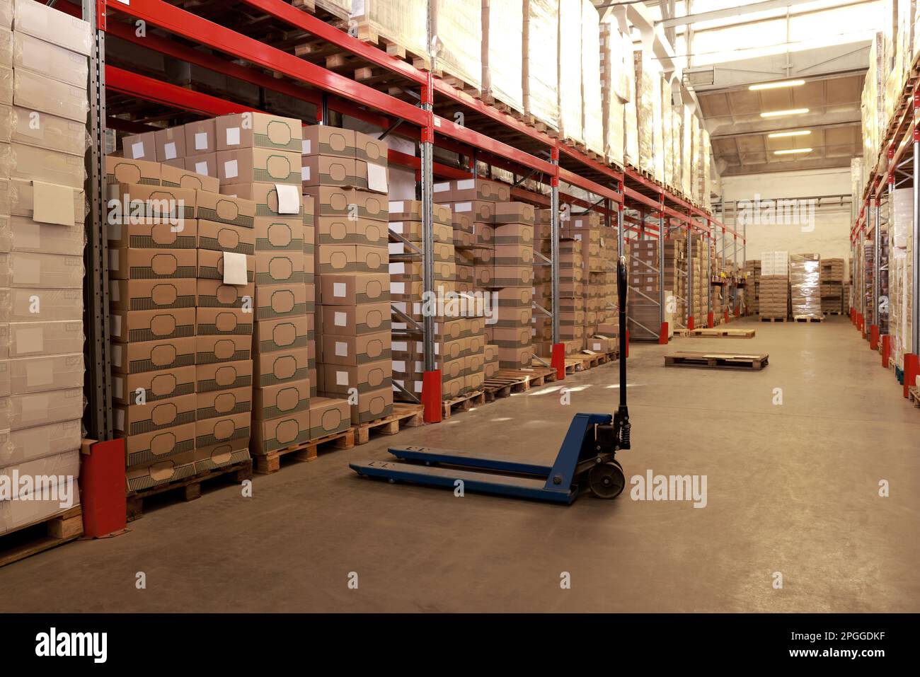Manual forklift near storage racks in warehouse. Logistics concept ...