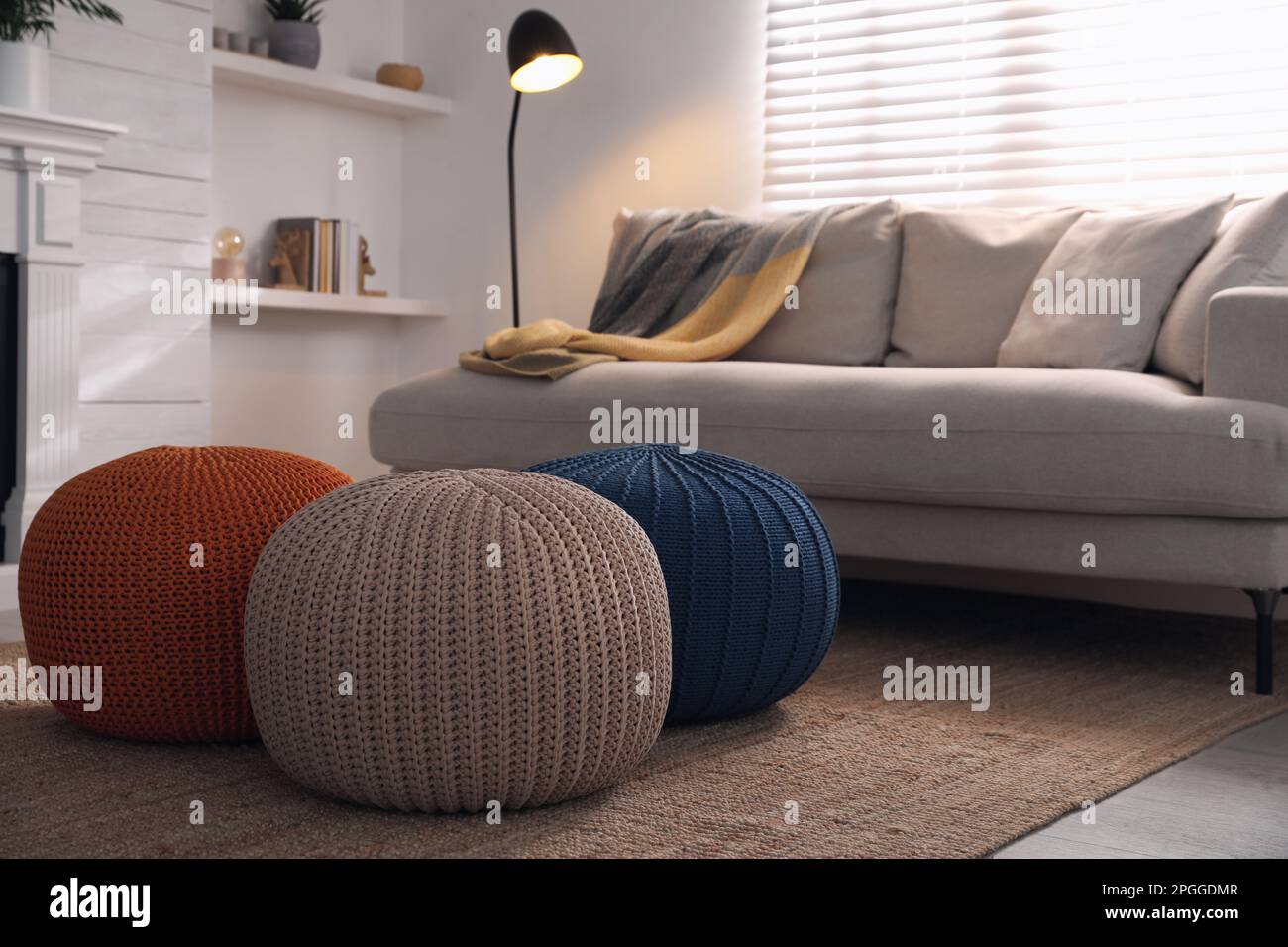 Stylish comfortable poufs near sofa in room. Home design Stock Photo ...