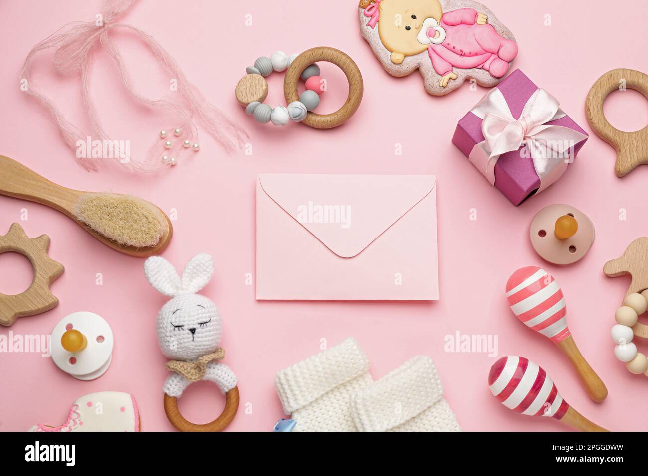 Envelope for baby shower and accessories on light pink background, flat ...