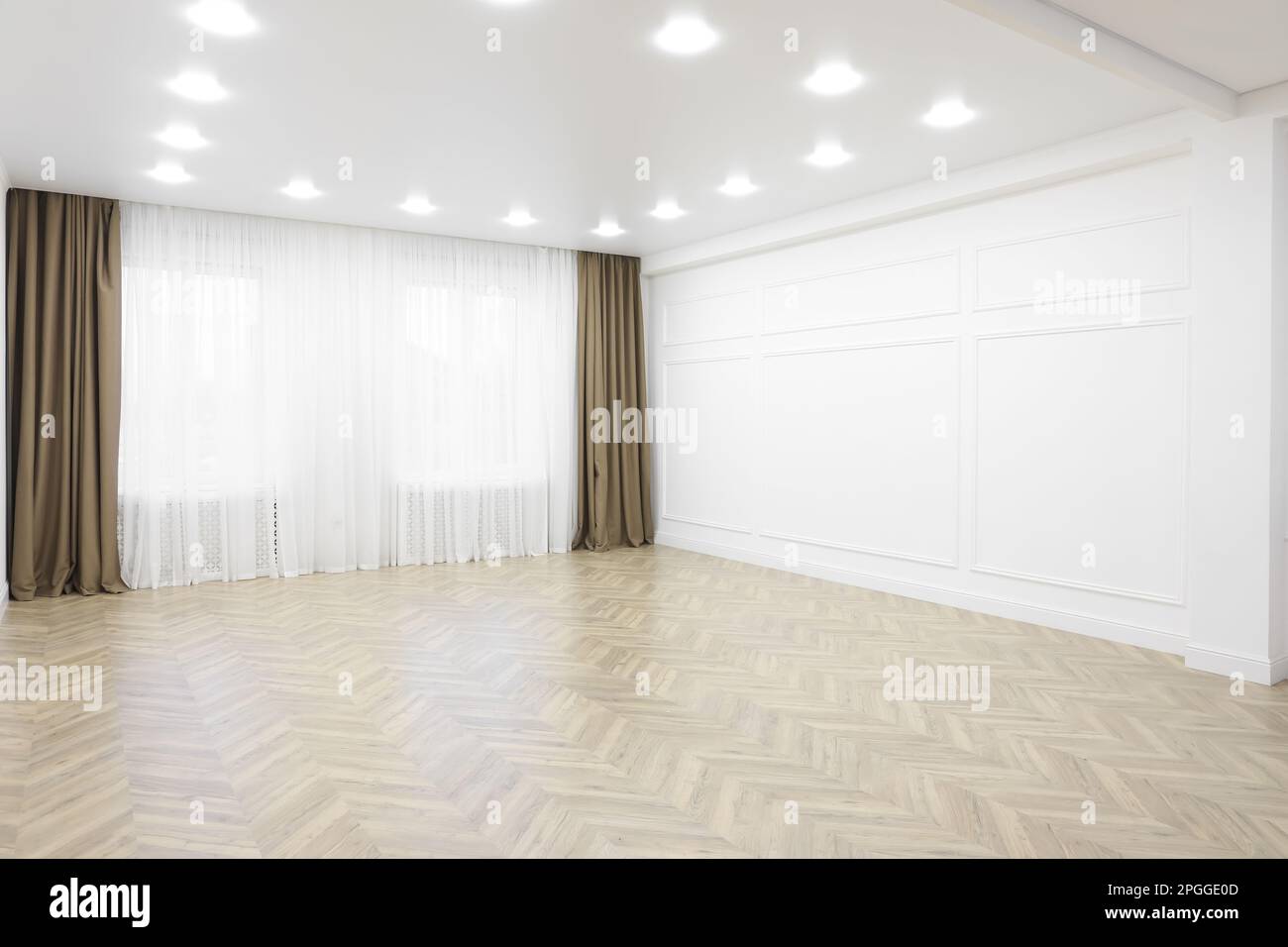 Empty room with white wall, wooden floor and spot lamps on ceiling ...