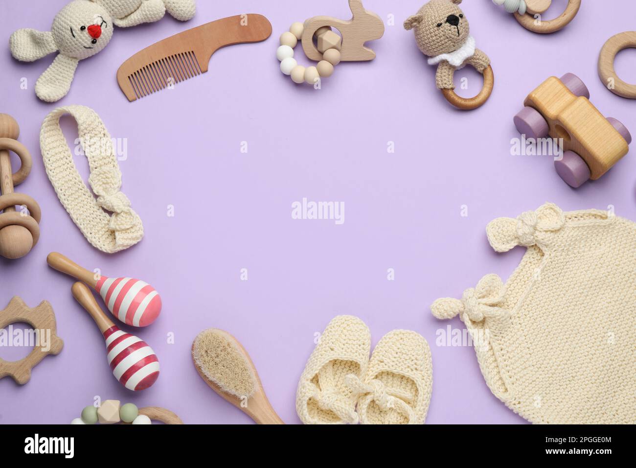 Frame of baby clothes and accessories on lilac background, flat lay ...
