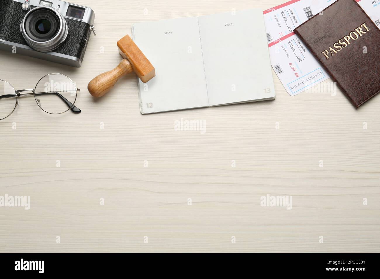 Flat lay composition with passports, stamp and flight tickets on wooden ...