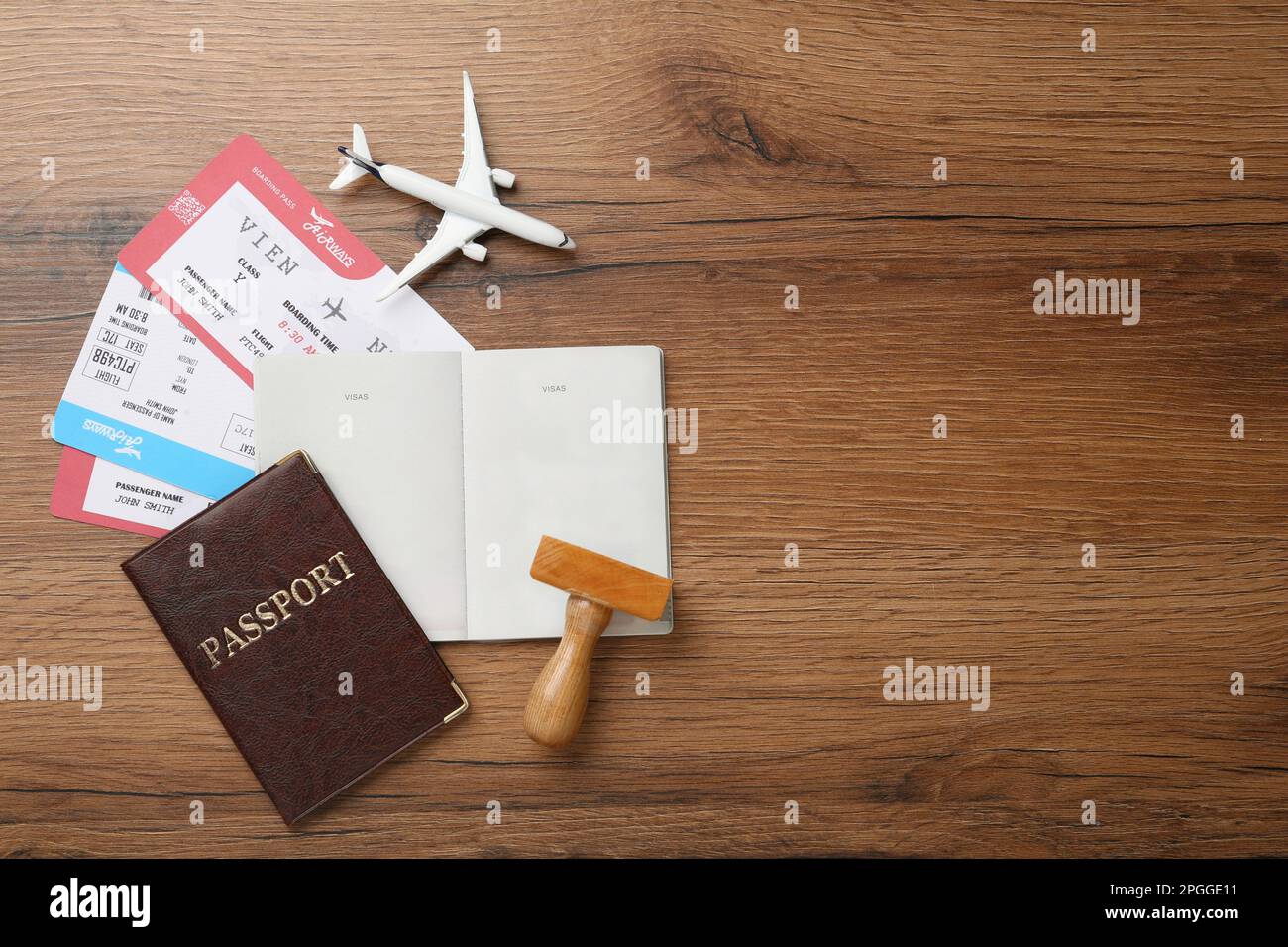 Flat lay composition with passports, stamp and flight tickets on wooden ...