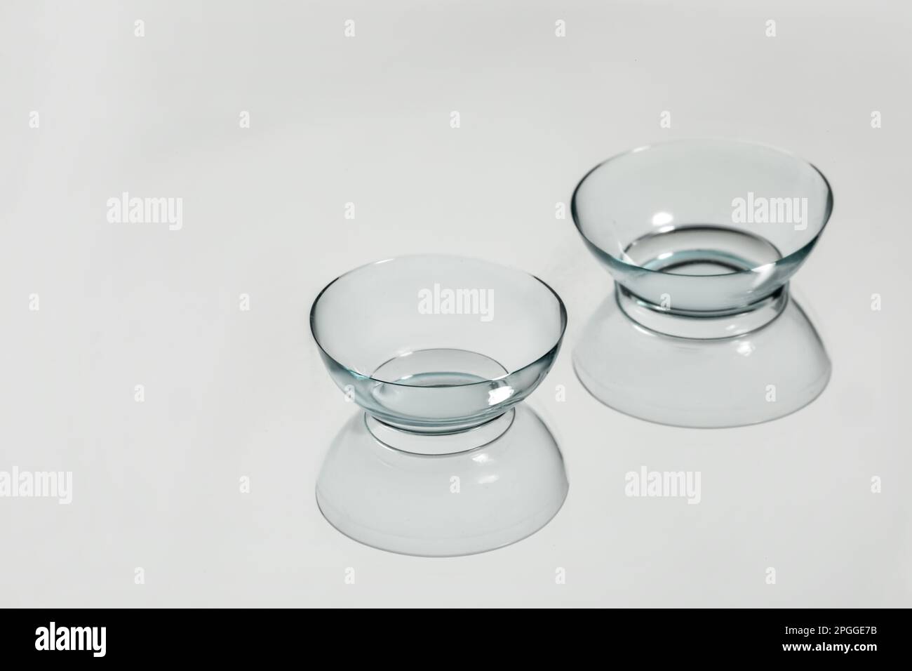 Pair of contact lenses on white reflective surface Stock Photo - Alamy