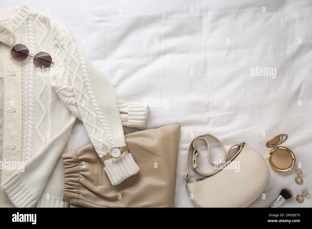 Fall fashion. Layout with woman's outfit on white bed, top view. Space ...