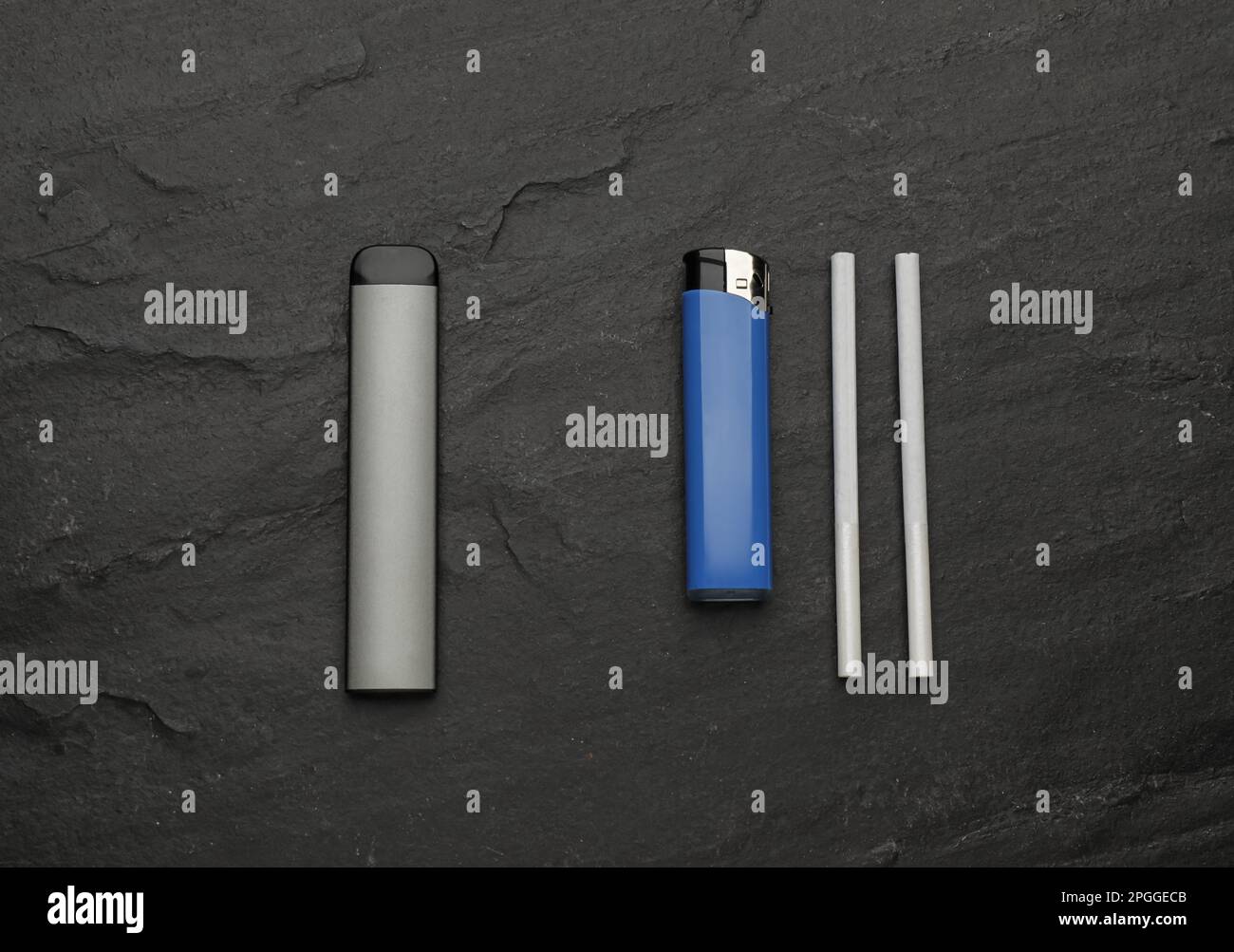 Disposable electronic smoking device near lighter and cigarettes on ...