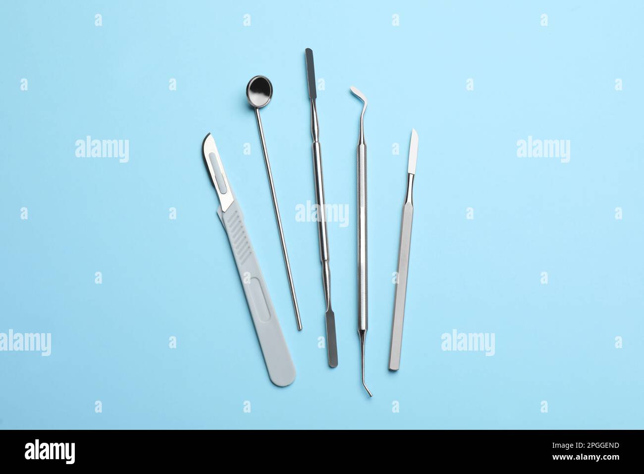 Set of different dentist's tools on light blue background, flat lay ...