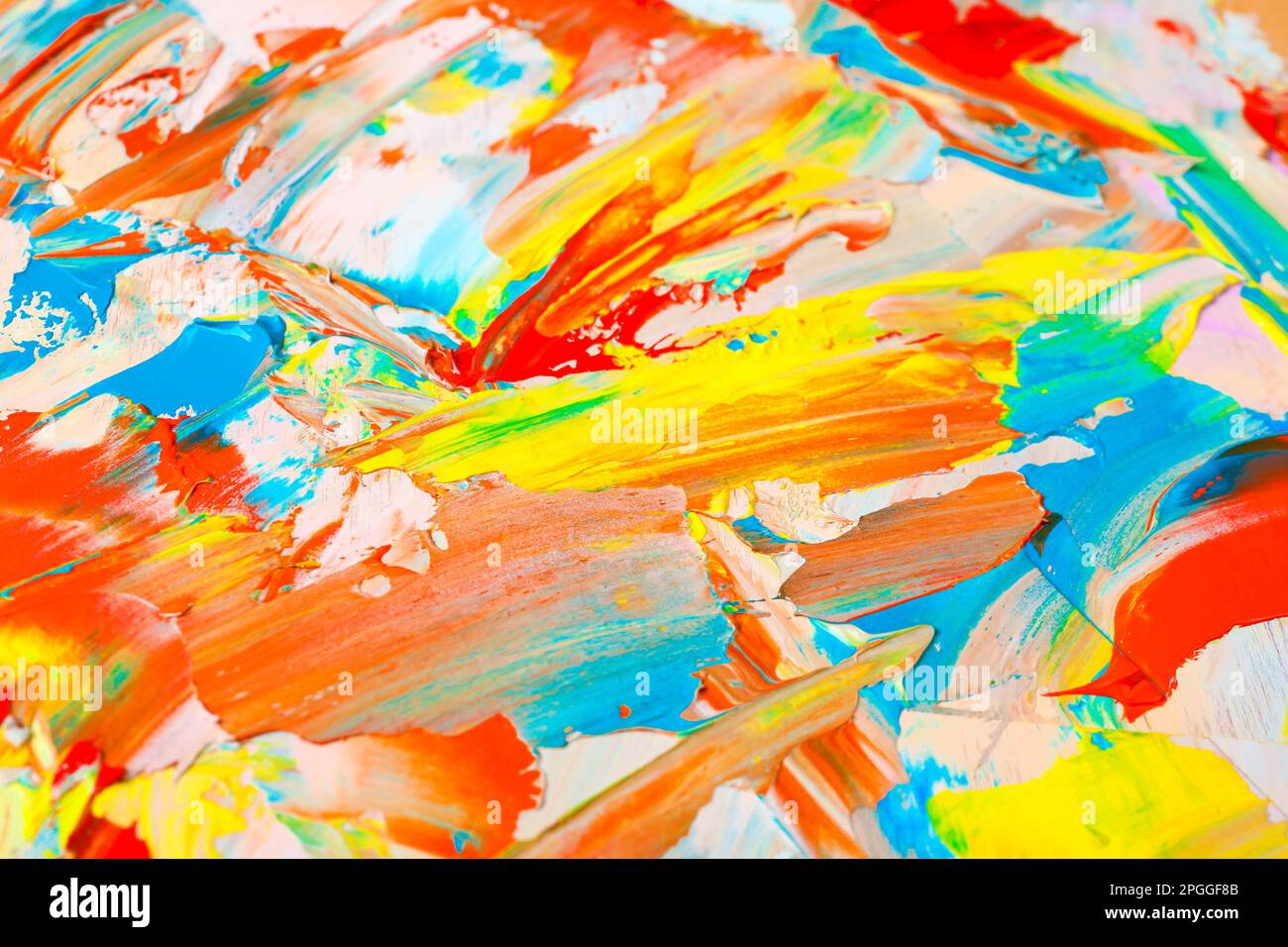 Closeup view of artist's palette with mixed bright paints as background ...