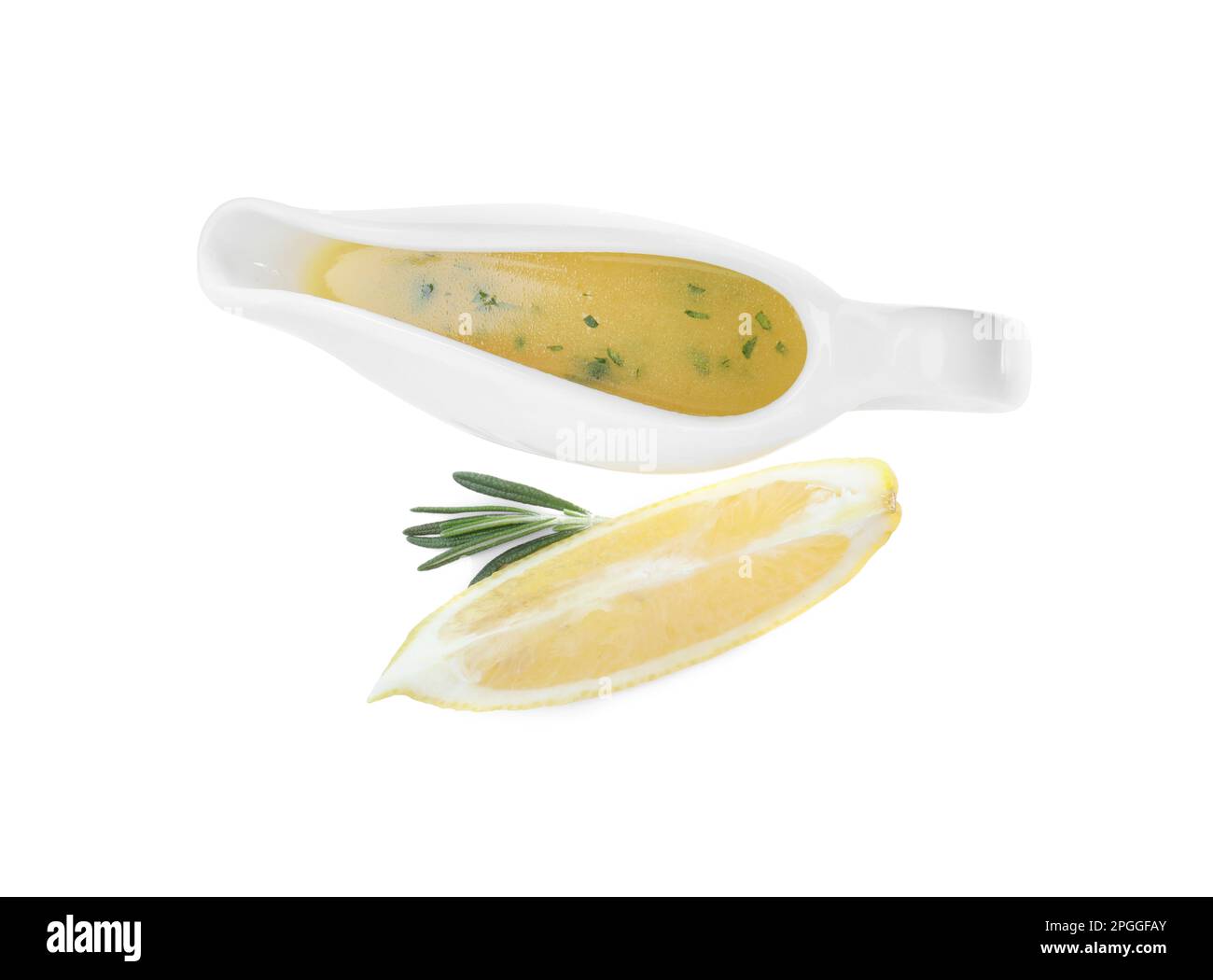 Ceramic sauce boat with lemon salad dressing and ingredients on white ...
