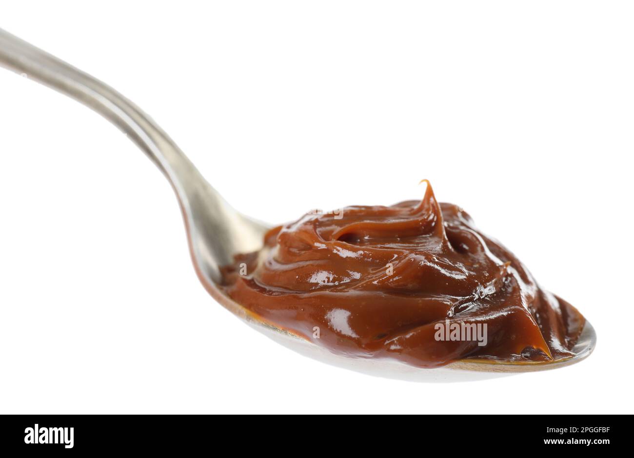 Spoon with tasty boiled condensed milk isolated on white Stock Photo ...