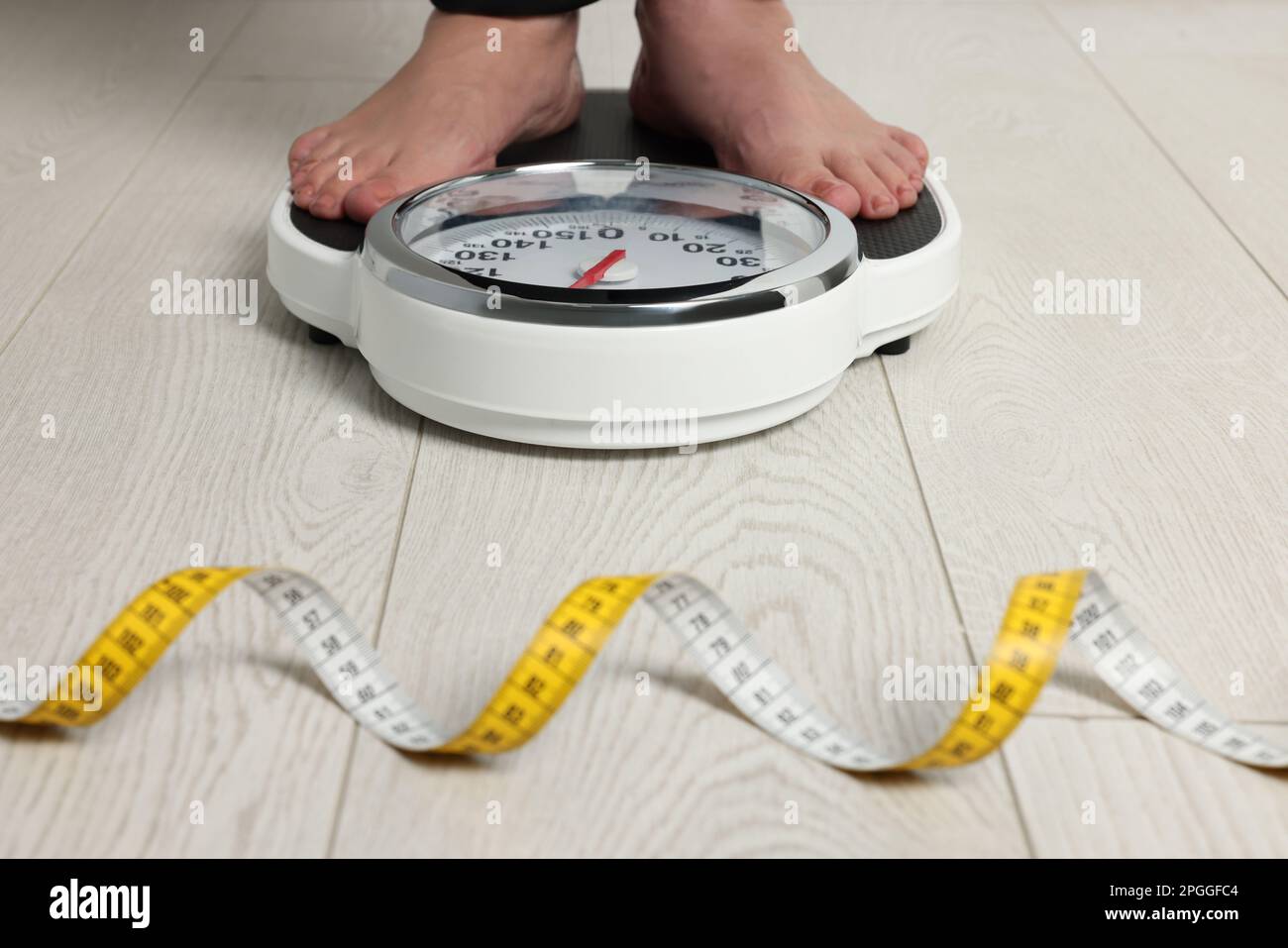 Overweight woman scales feet hi-res stock photography and images - Alamy