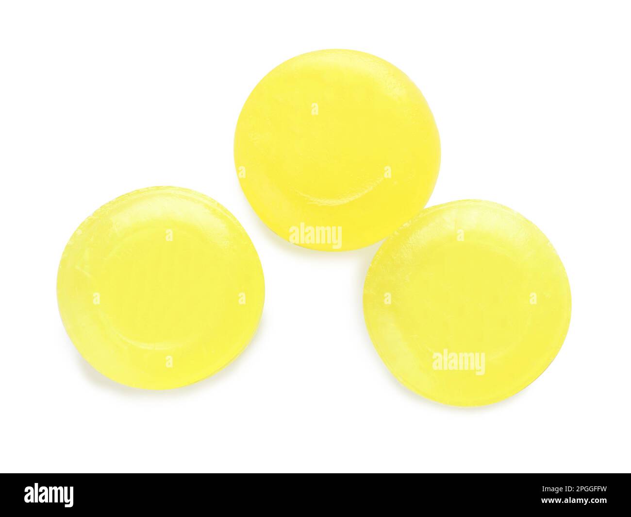Three yellow cough drops on white background, top view Stock Photo - Alamy